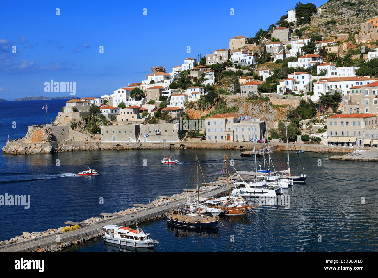 Vivid view of Hydra Island harbor, Greece, with turquoise waters ...