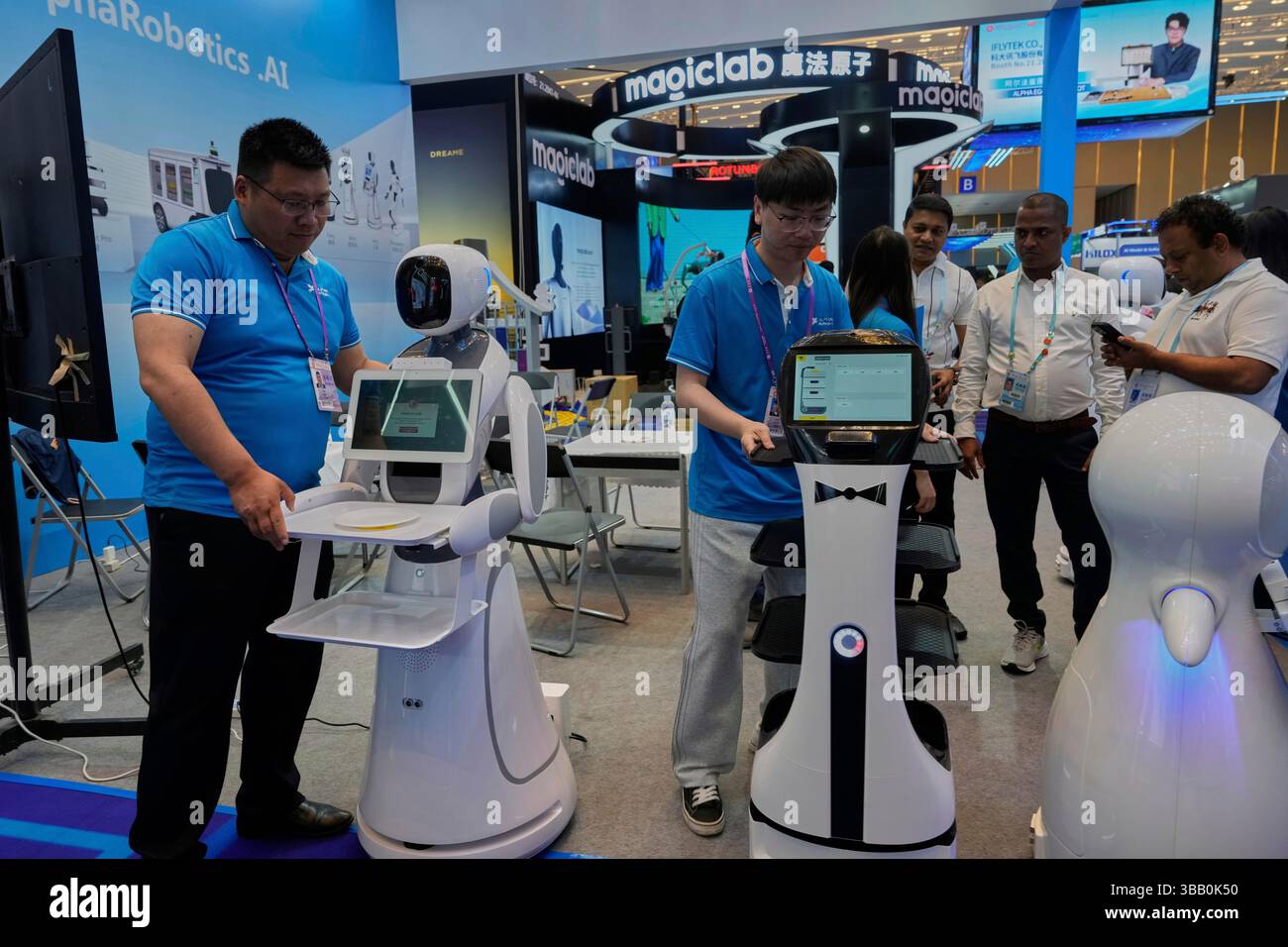 FILE - Vendors from AlphaRobotics.AI show off service robots at the ...