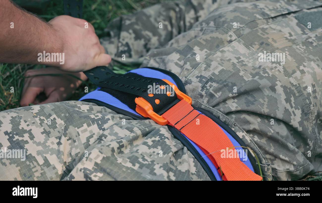 Emergency Tourniquet Applied on Camouflaged Pants. Applying Tourniquet ...