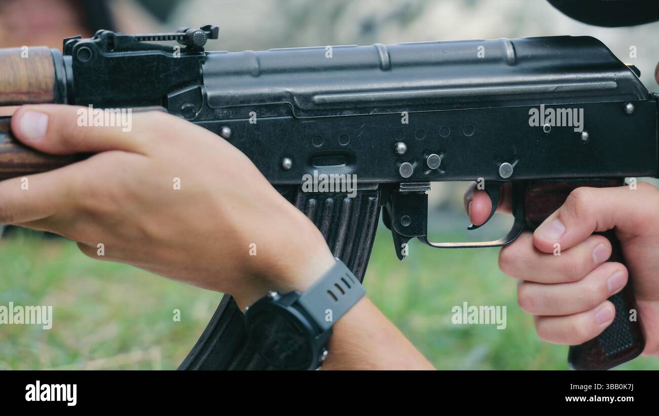 Close-Up of Hands Holding Rifle in Action. Detailed view of hands ...