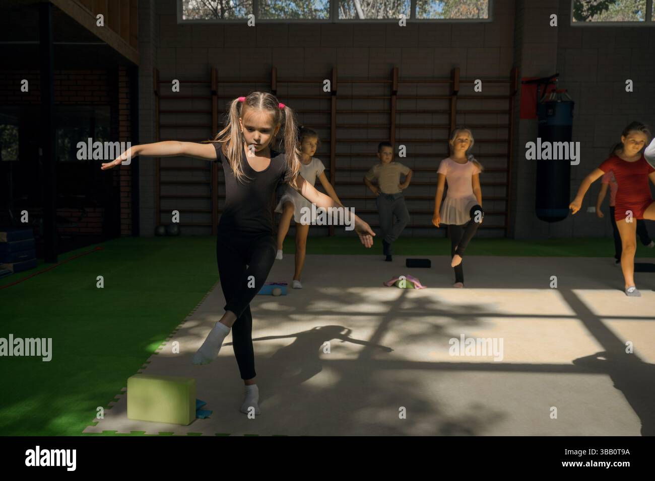 Training of children in the gym. Gymnastics, circus, fitness for girls ...