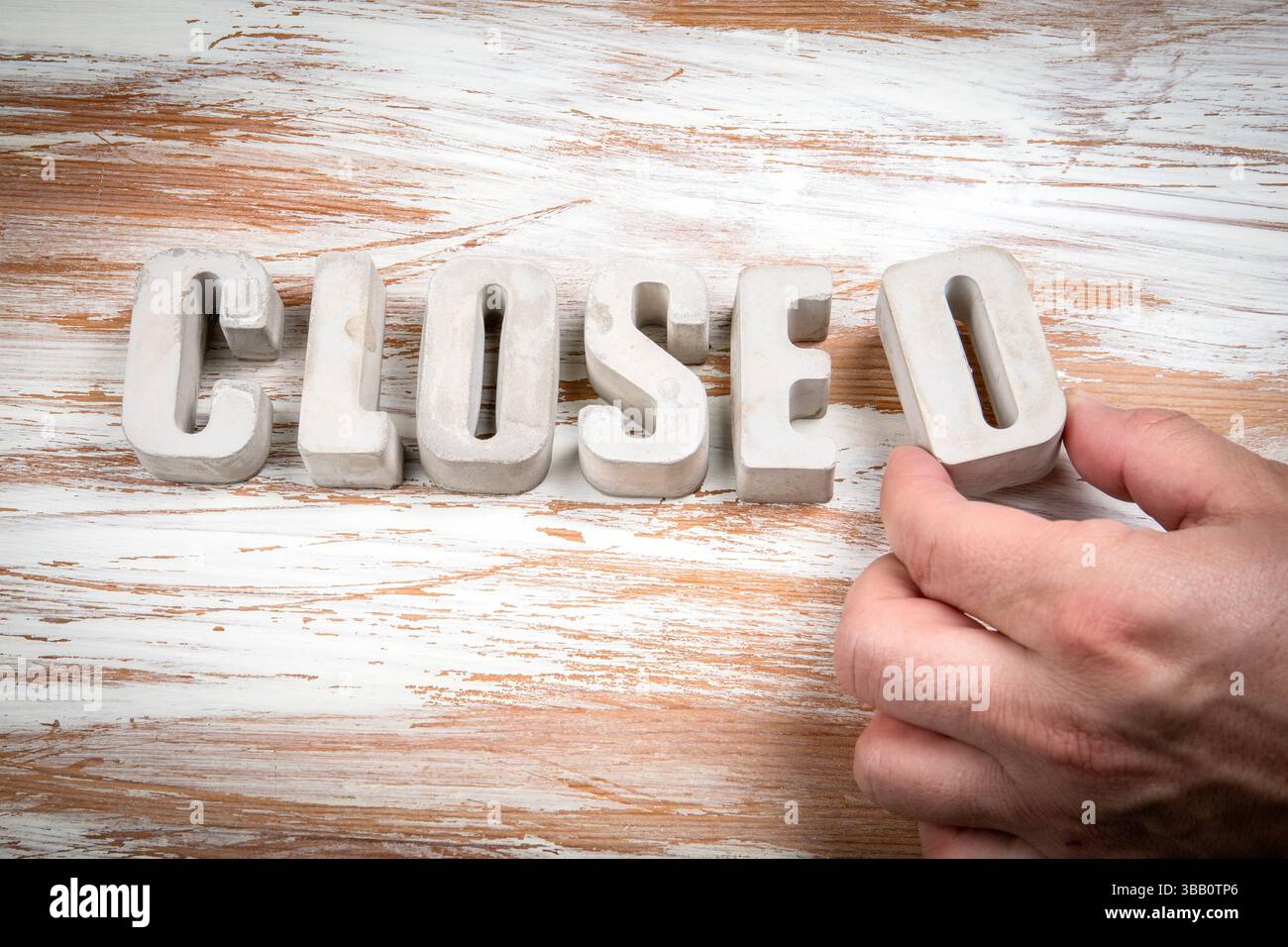 Closed. Concrete alphabet letters on a light painted wood texture ...