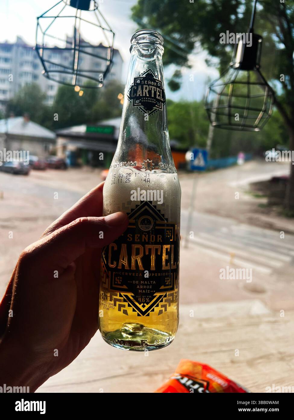 Kyiv, Ukraine - May 14, 2025: Hand grasping a transparent Senor Cartel ...
