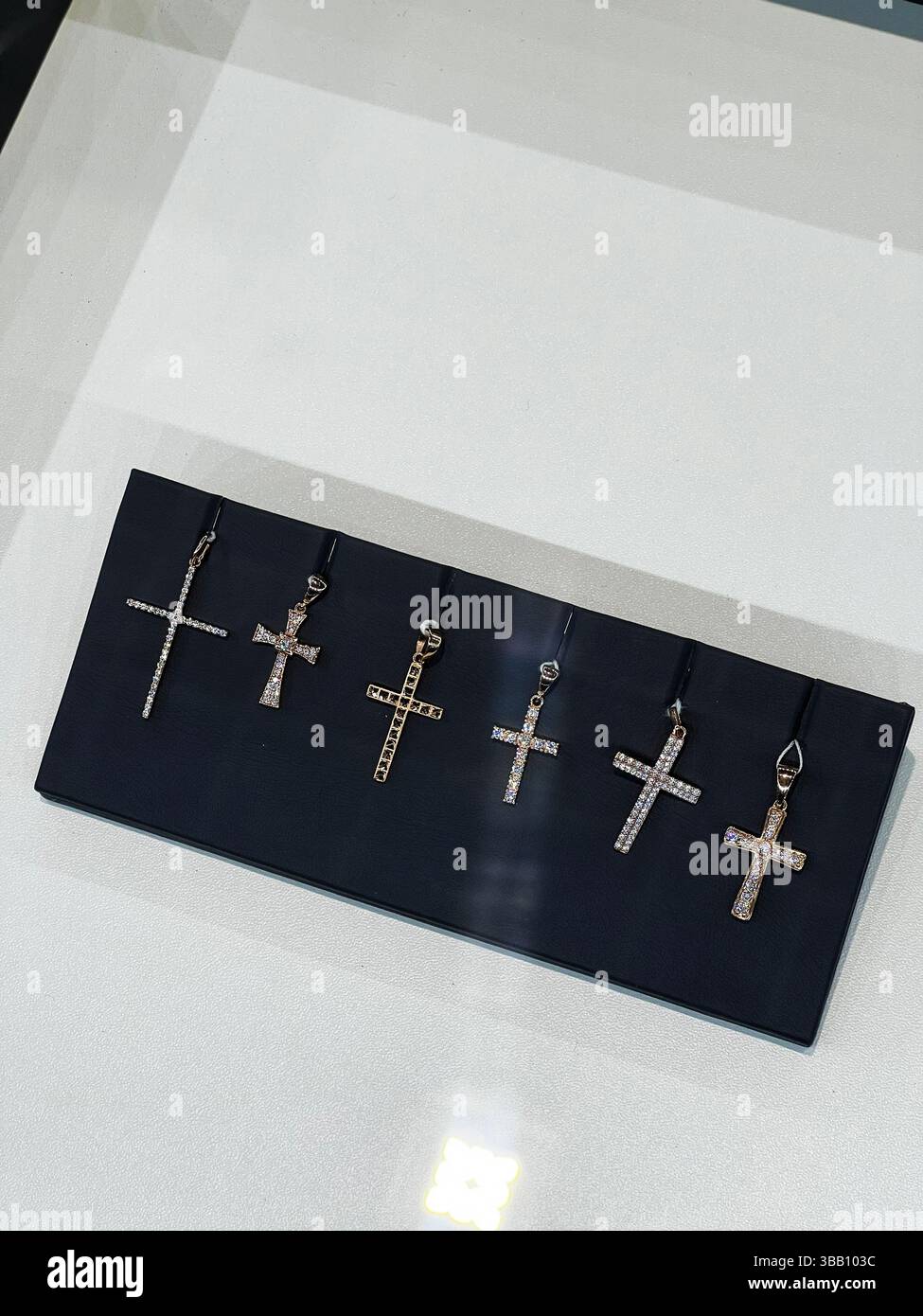 Various styles of cross pendants featuring metallic designs and ...