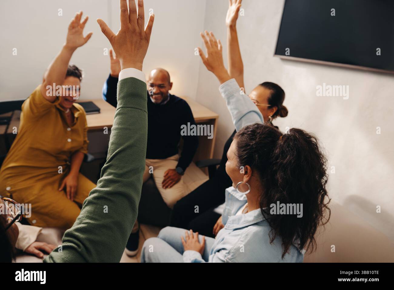 A diverse group of team members participating together in a workplace ...