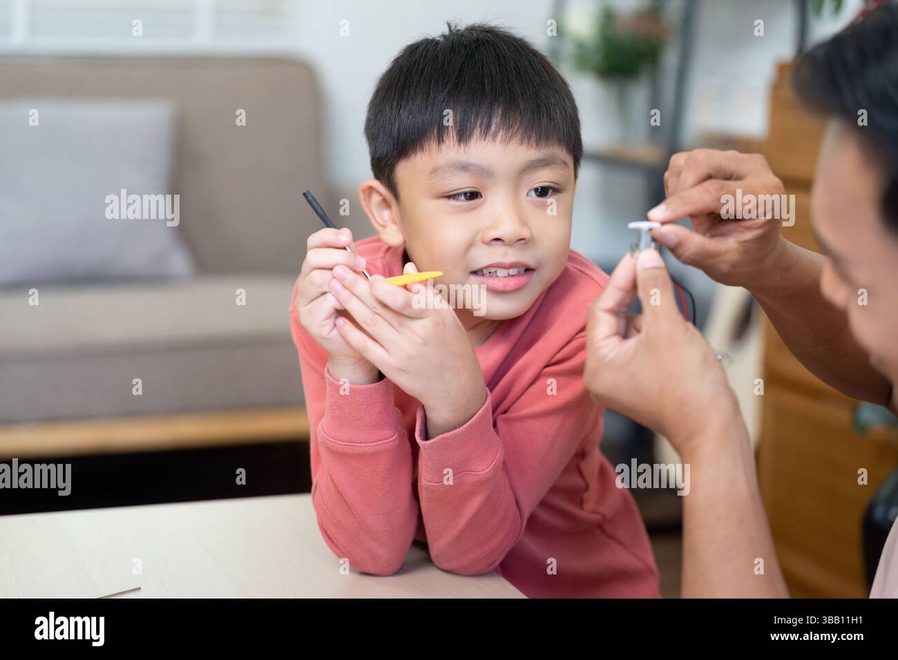 Activity of father and son having fun with DIY learning tools Stock ...