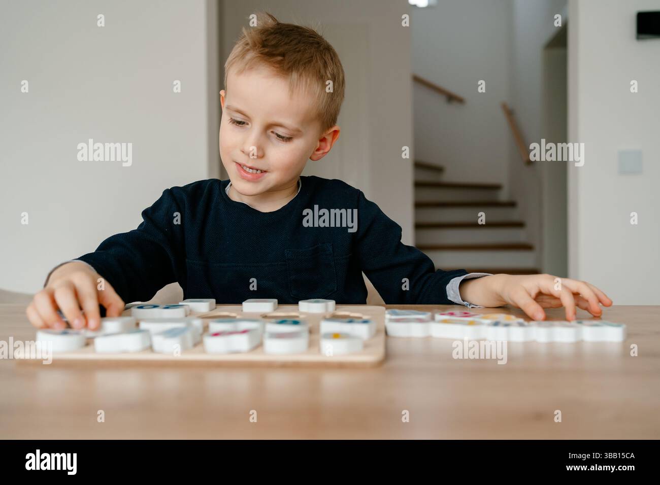 boy learns to count by laying out numbers from 1 to 20 on the board ...