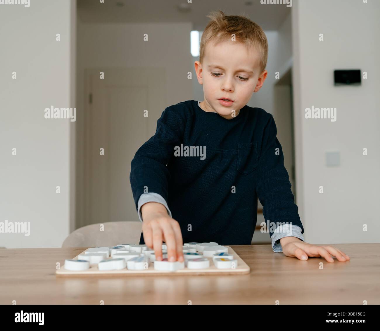boy learns to count by laying out numbers from 1 to 20 on the board ...
