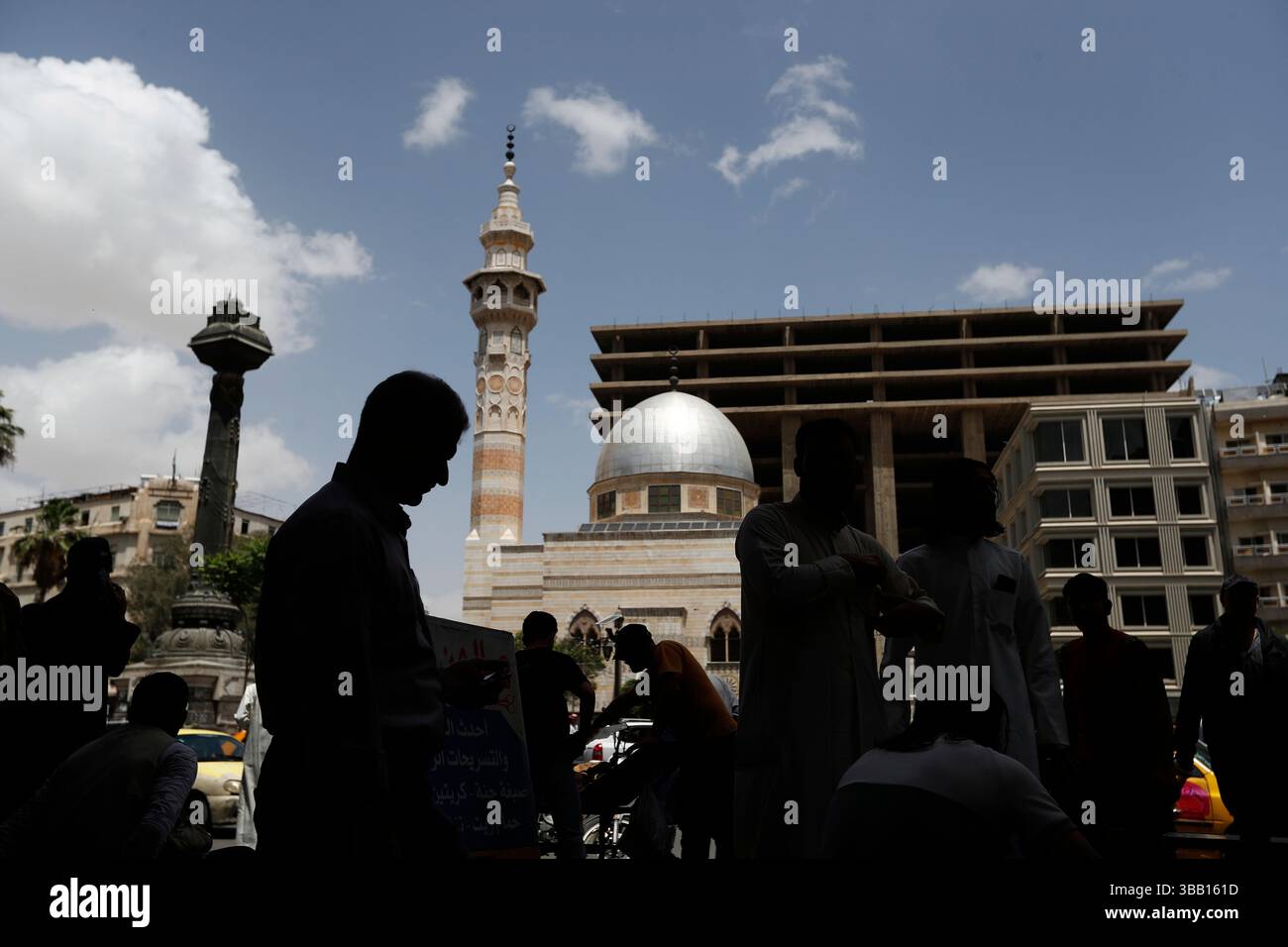 Syrians walk on a street in Damascus, Syria, Wednesday, May 14, 2025 ...