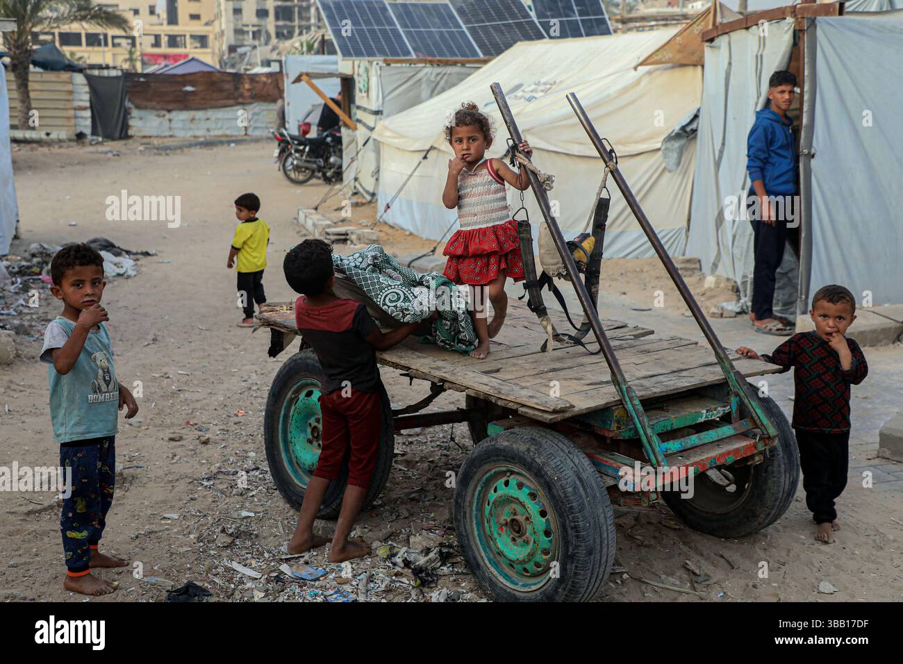 Gaza. 13th May, 2025. Displaced Palestinian children are seen at a ...