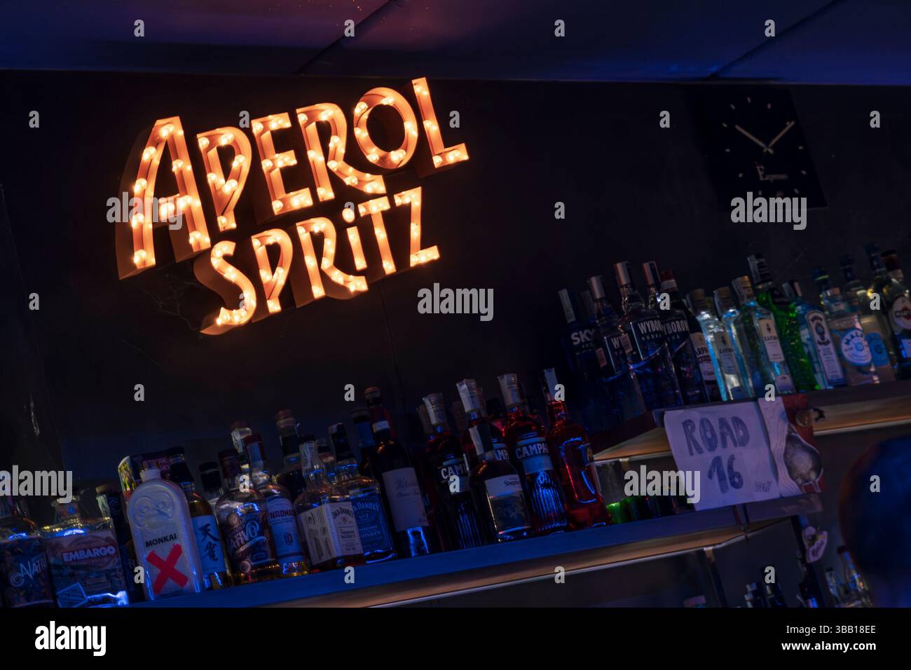 Rome, italy 4 may 2025: an illuminated aperol spritz sign adds a warm ...