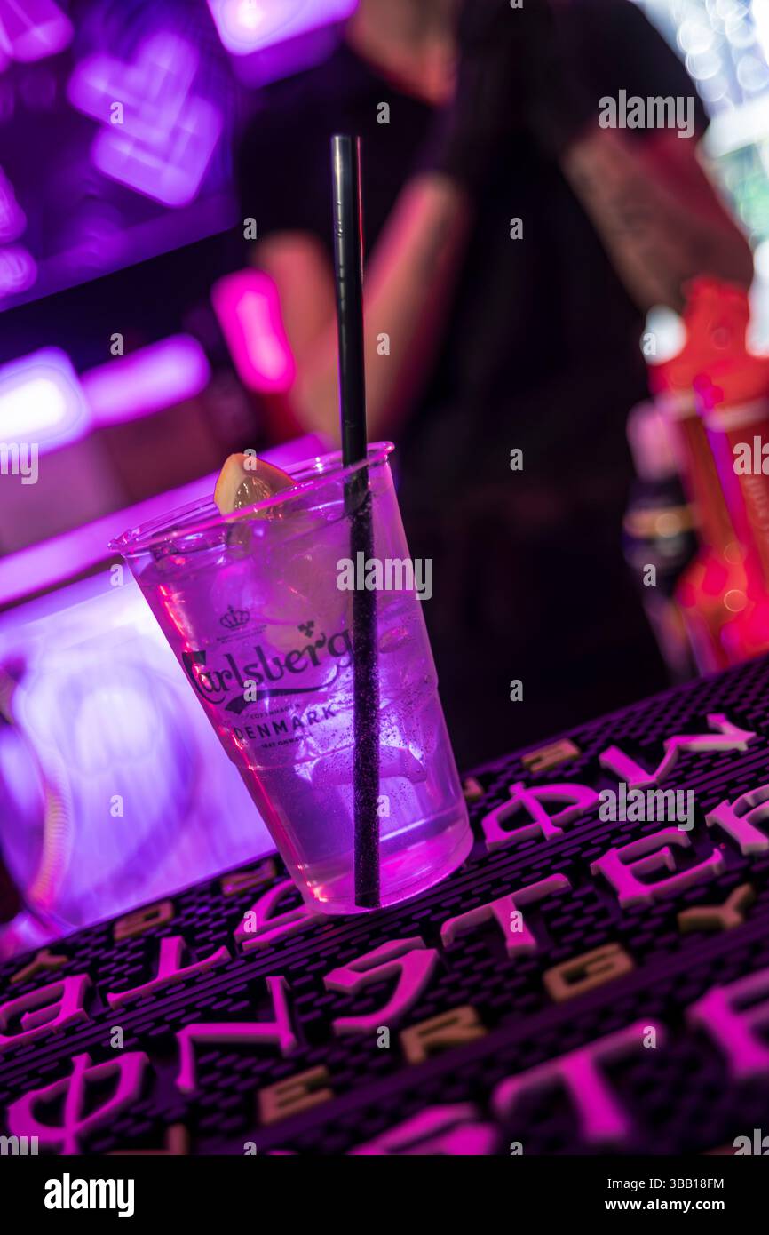 Rome, italy 4 may 2025: plastic cup with carlsberg beer, ice, lemon and ...