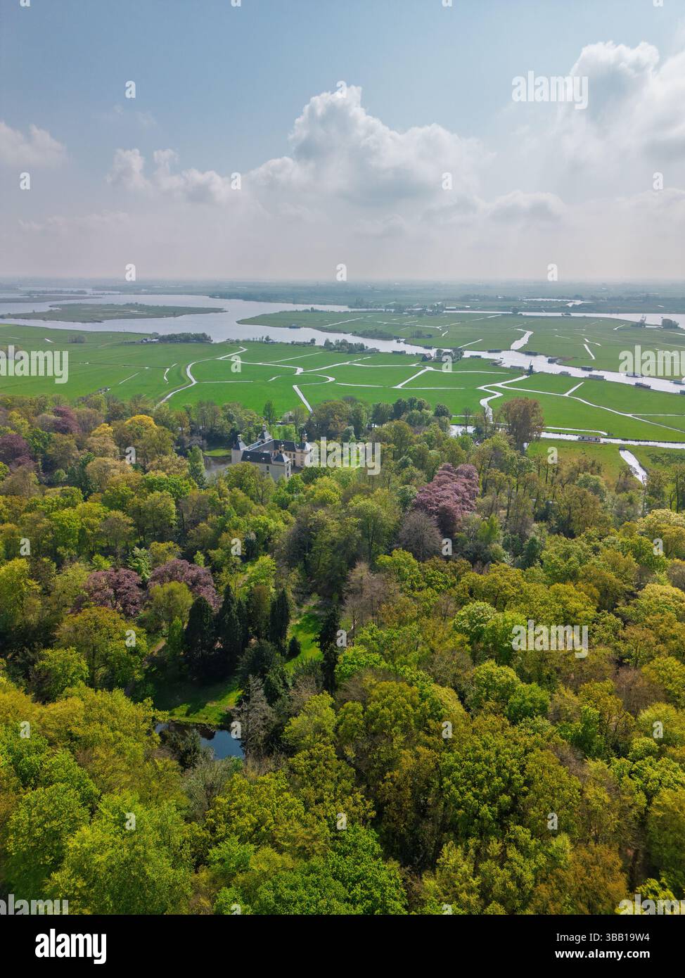 Aerial view of a historic castle surrounded by a forest, with vast ...