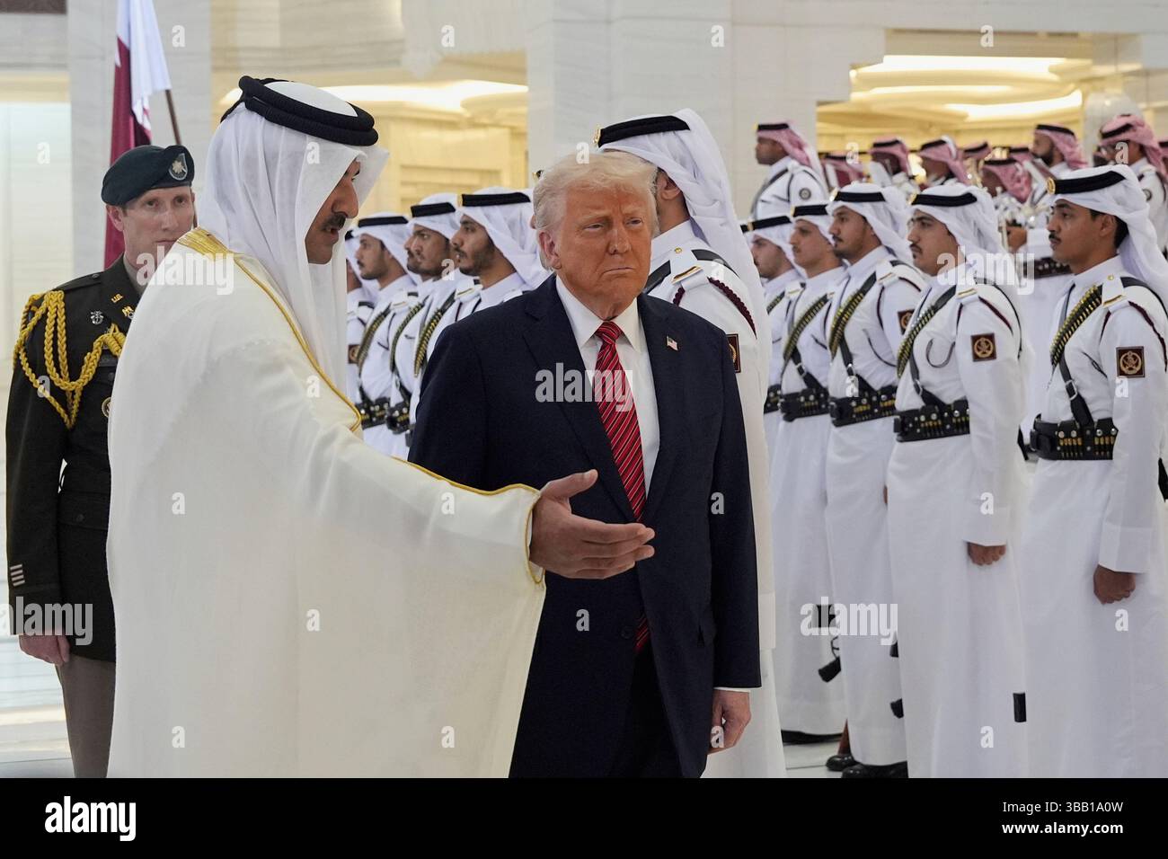 Qatar's Emir Sheikh Tamim bin Hamad Al Thani welcomes President Donald Trump during an official ...
