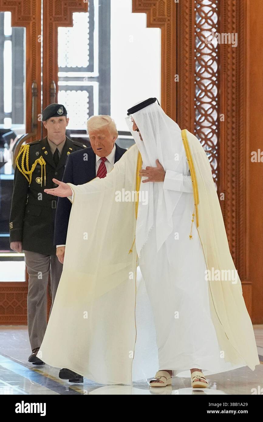 Qatar's Emir Sheikh Tamim bin Hamad Al Thani welcomes President Donald Trump during an official ...