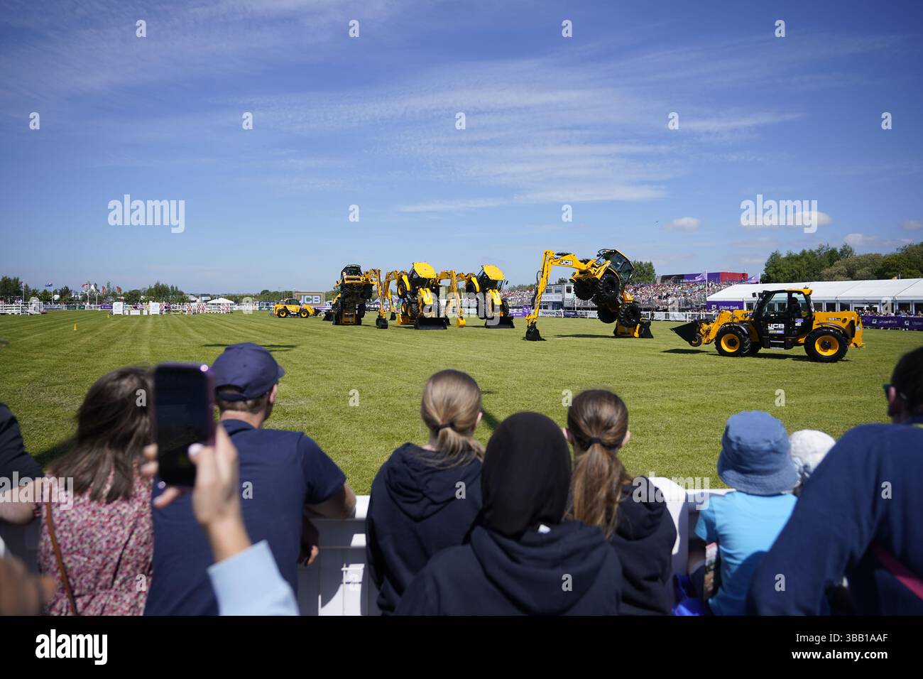 People watching 'JCB Dancing Diggers' during the first day of the ...