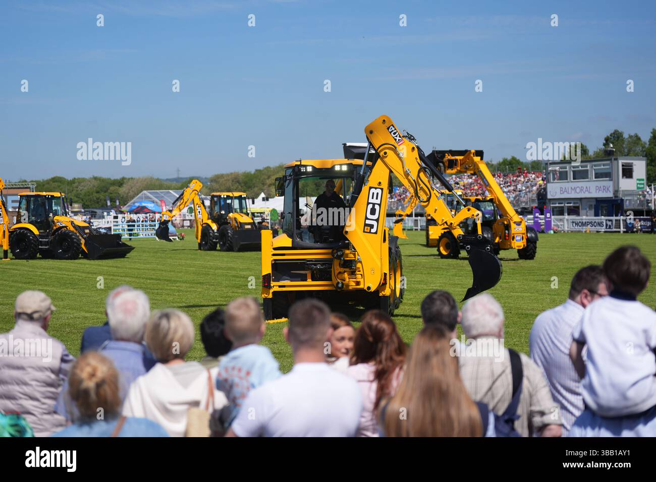People watching 'JCB Dancing Diggers' during the first day of the ...