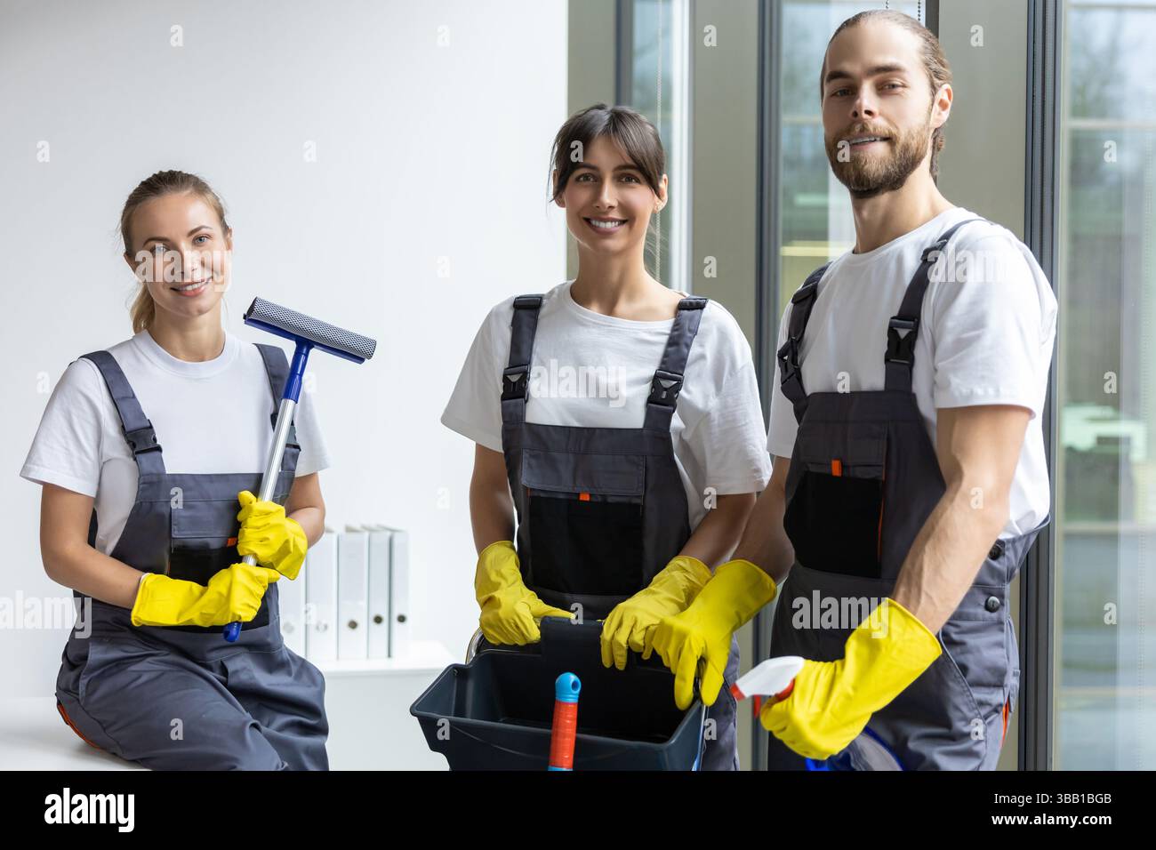 Team of housekeeping staff standing near the window in the office Stock ...