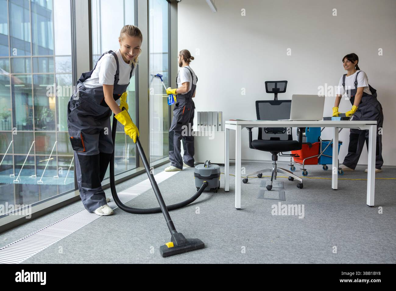 Housekeeping team cleaning the conference room and looking busy and ...