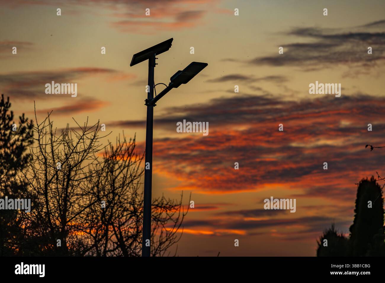 Modern street lamp, lighting pole with a lamp powered by a solar panel ...