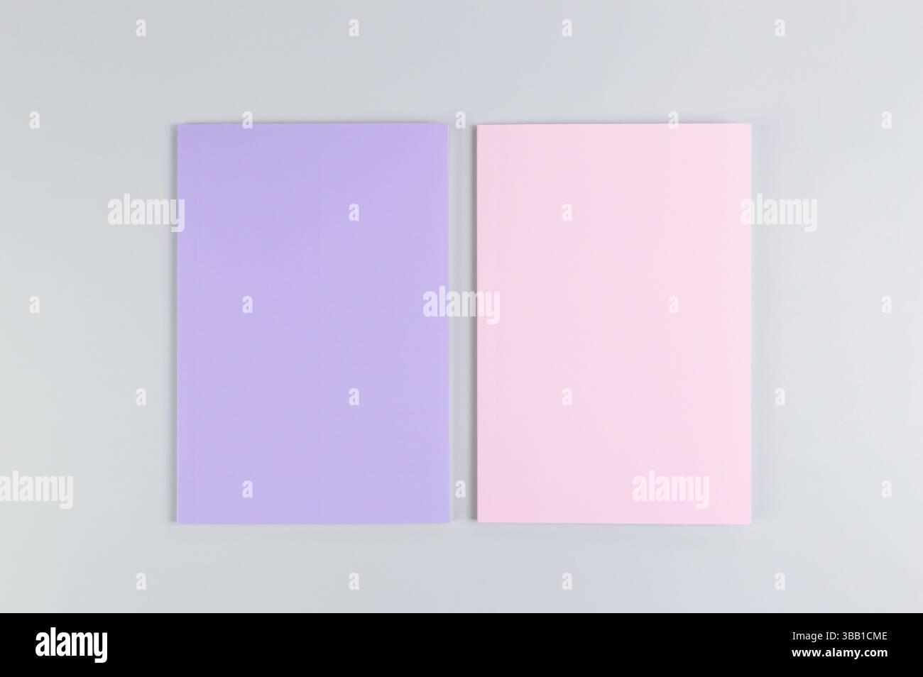 Top view of pink and purple notebooks on grey background. School ...