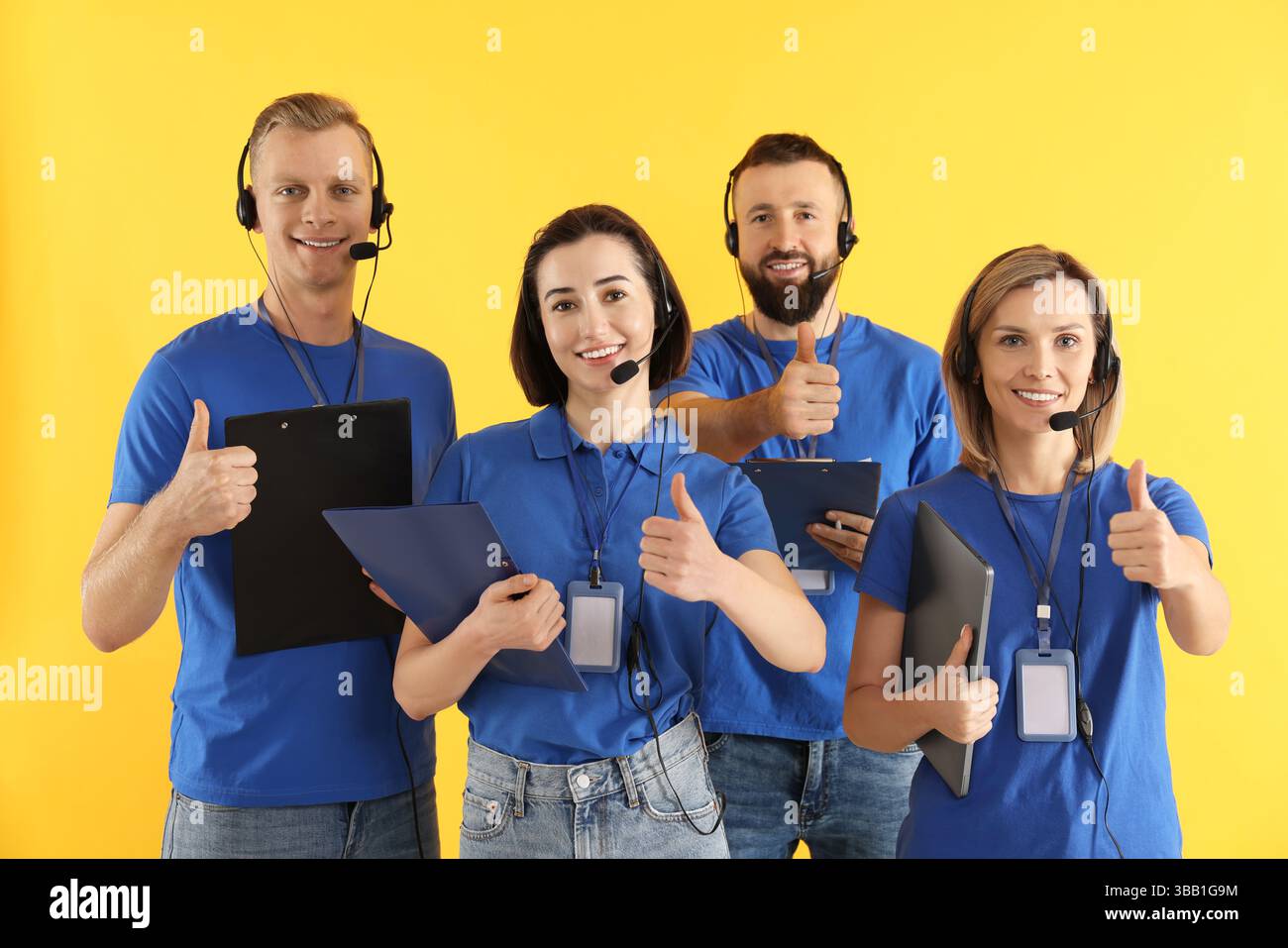 Technical support call center. Team of friendly operators showing ...