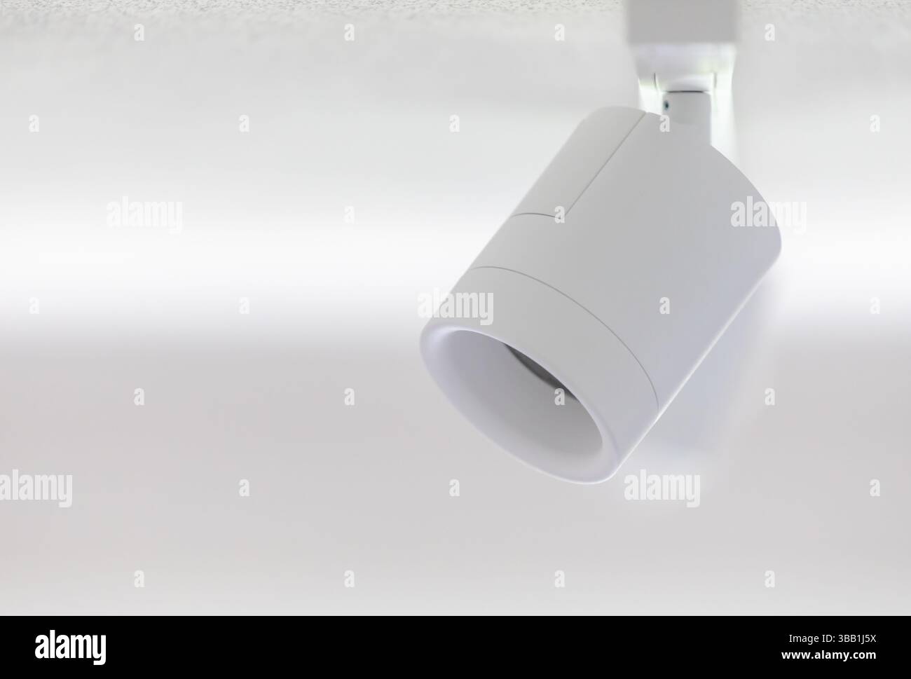 Cylindrical track lighting fixture mounted on a white ceiling hi-res ...