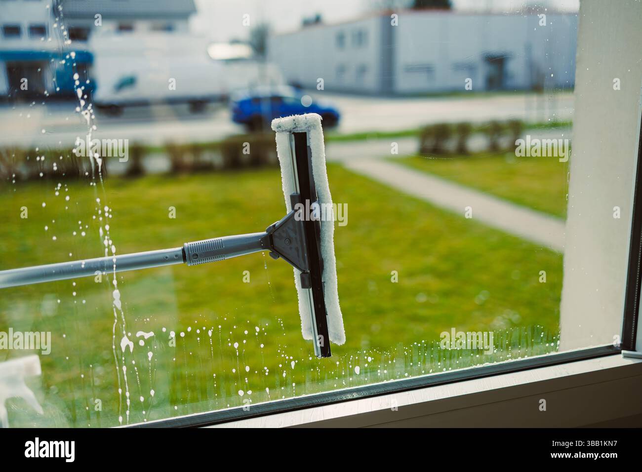 Professional cleaning worker washes windows with special equipment ...