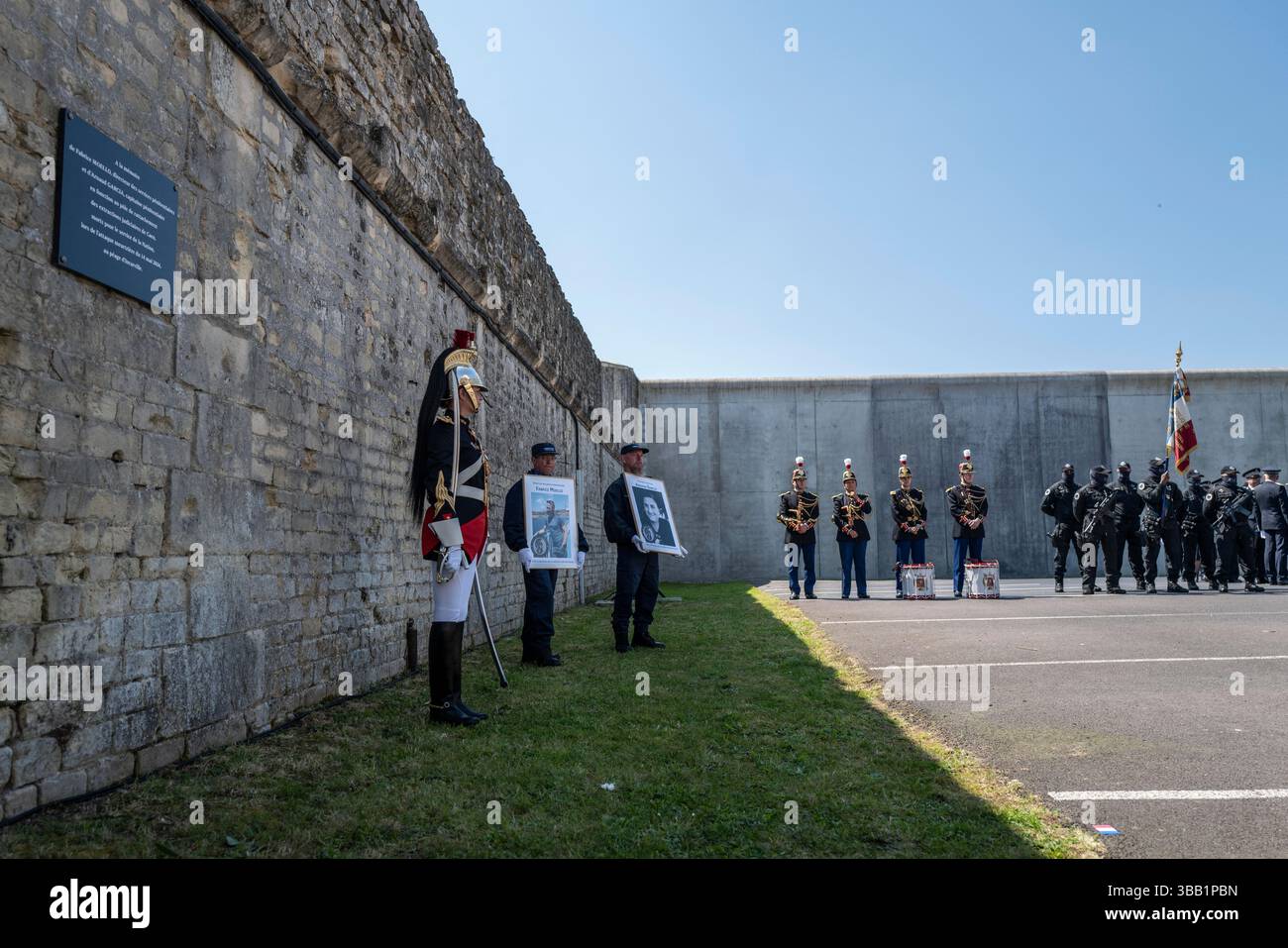 French prison officers, hold portraits of the two victims during a ...