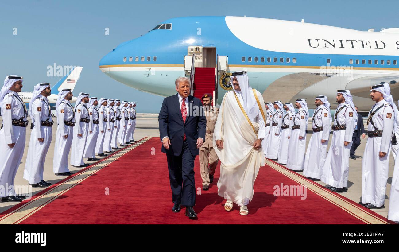 Doha, Qatar. 14th May, 2025. U.S. President Donald Trump walks with ...