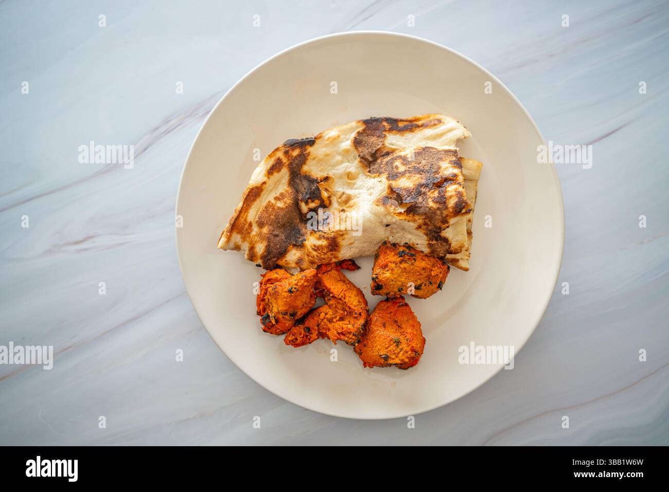 Spicy Chicken Tikka served butter naan bread Stock Photo - Alamy