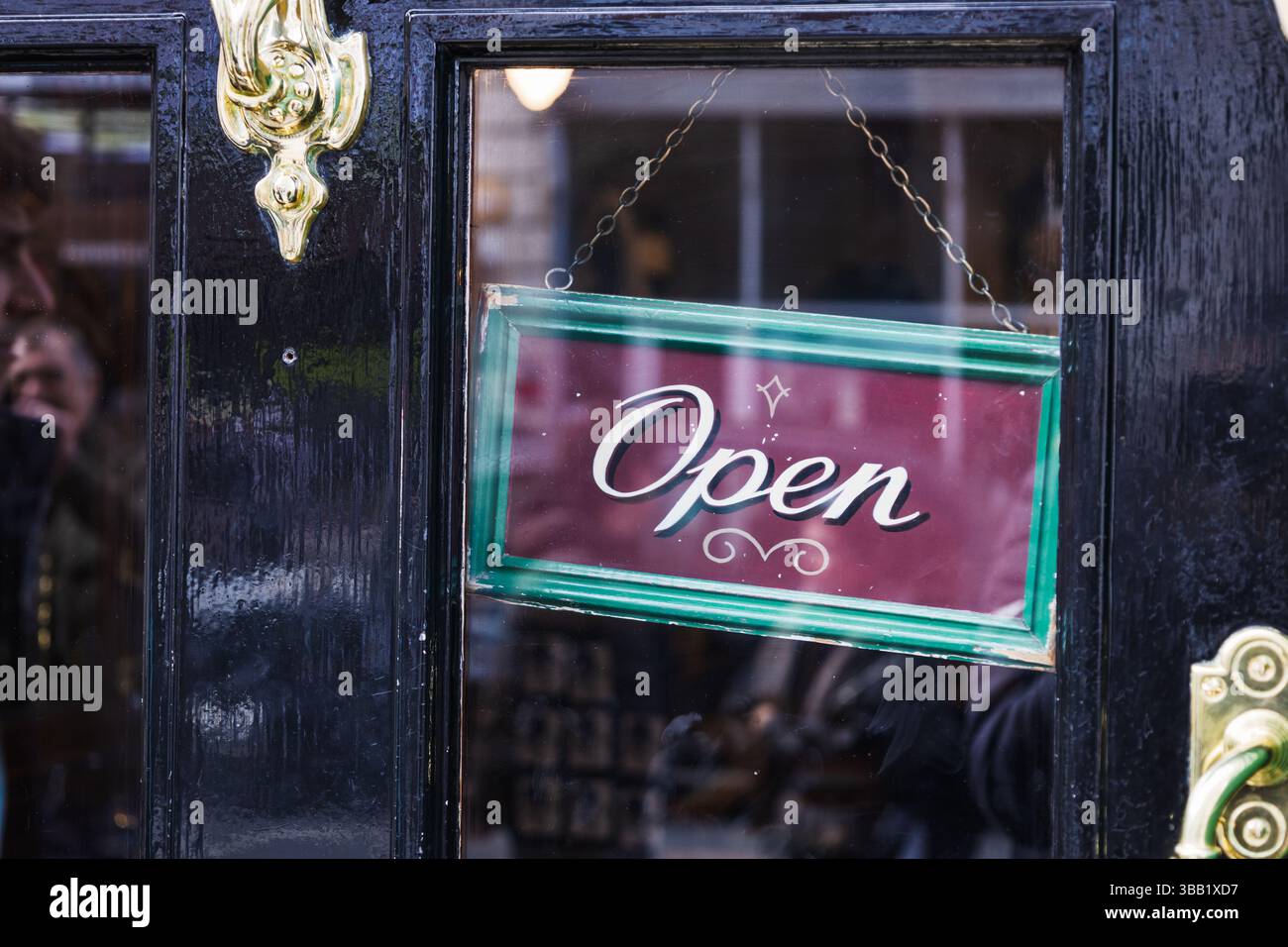 Open Sign Displayed in Window of Black Storefront Inviting Customers ...