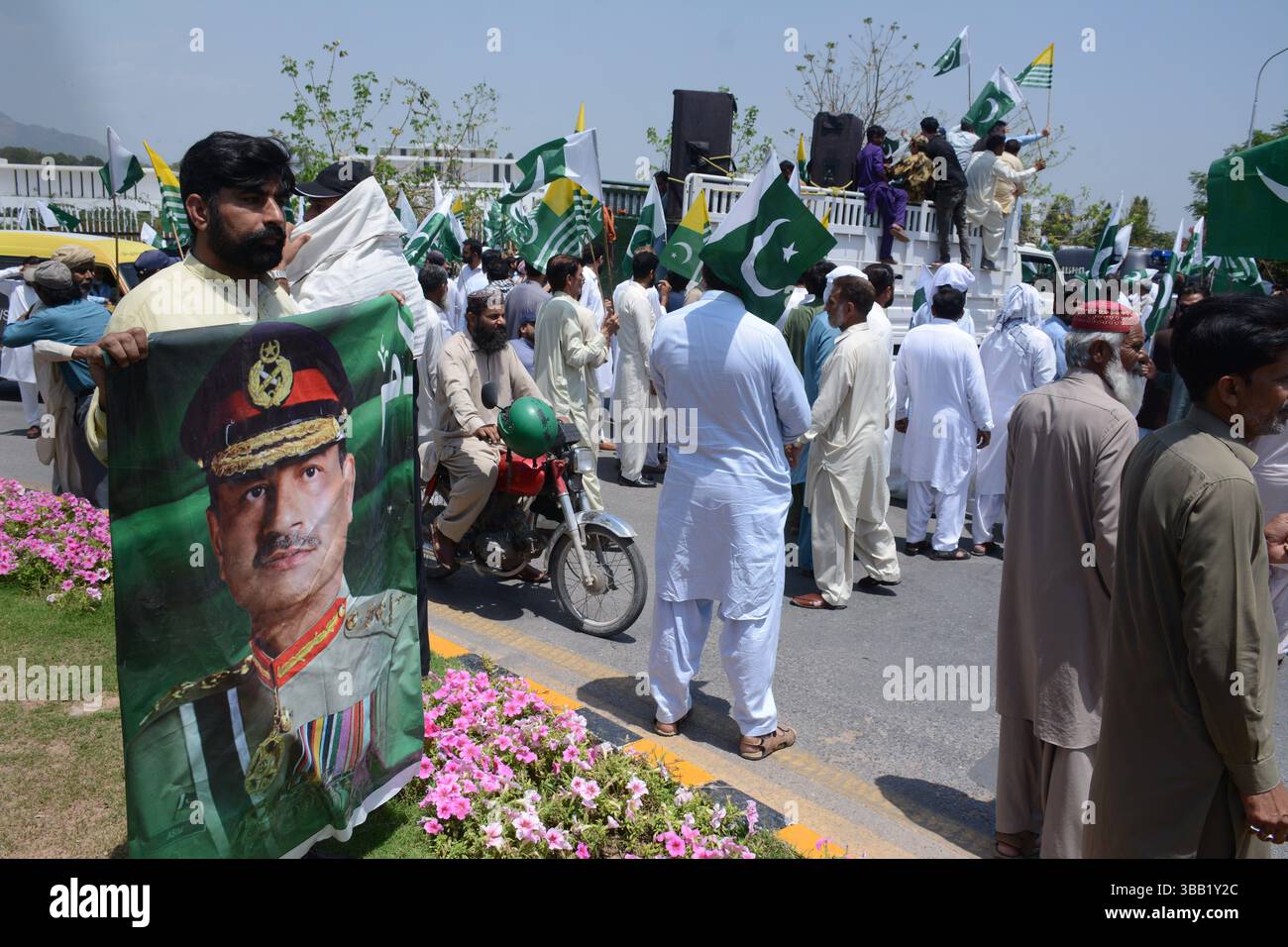 Islamabad, Pakistan. 14th May, 2025. People hold flags as they march ...