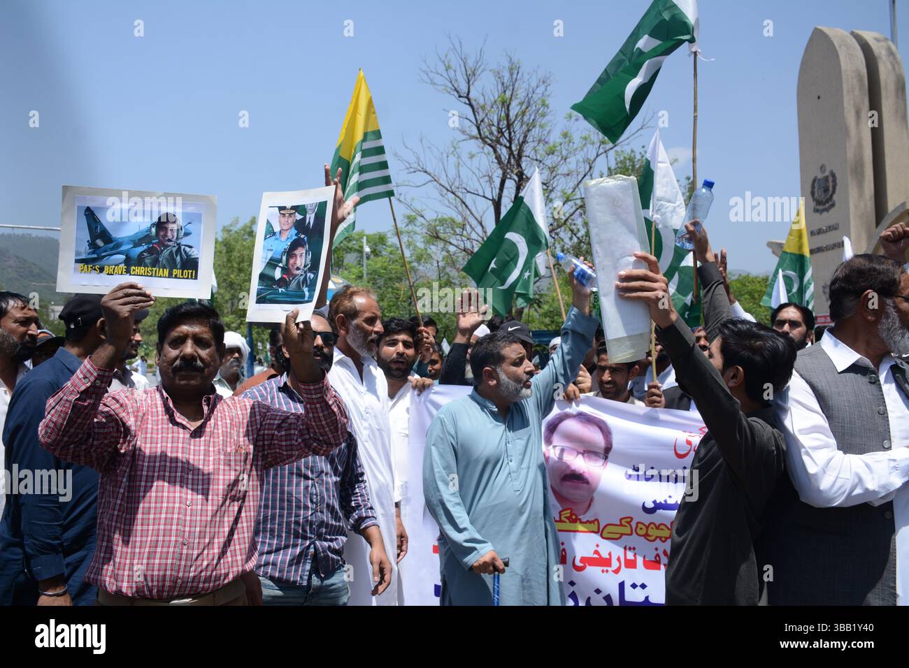 Islamabad, Pakistan. 14th May, 2025. People hold flags as they march ...