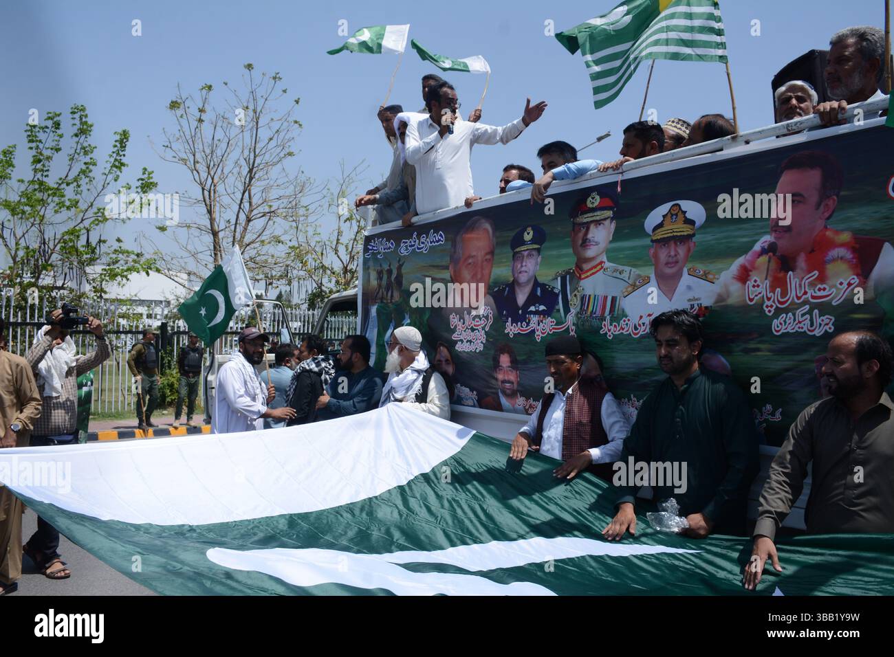 Islamabad, Pakistan. 14th May, 2025. People hold flags as they march ...