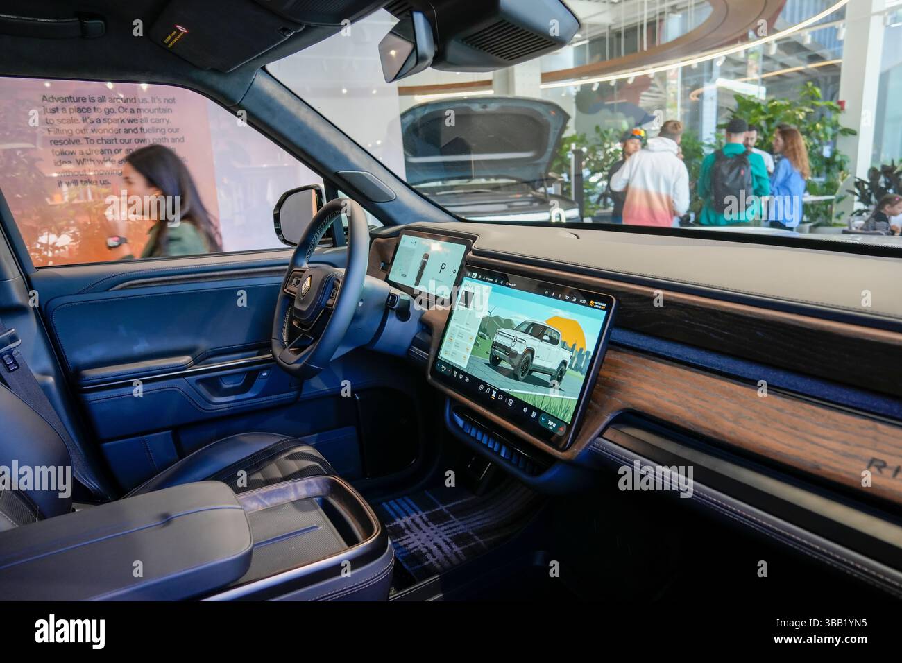 Fans of Rivian electric vehicles at the reopening of Rivian Spaces in ...