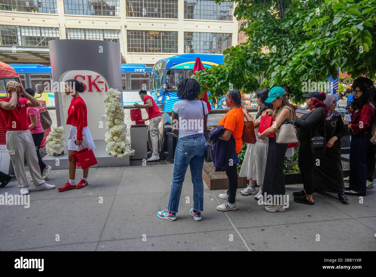 Shoppers line up for samples and drinks at a brand activation for the ...