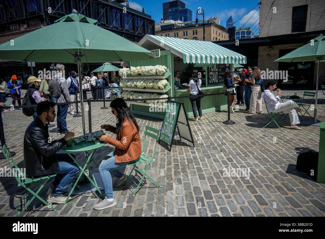 People line up for free coffee based drinks and other beverages at a ...