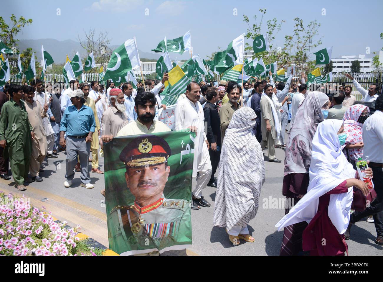 Islamabad, Pakistan, Pakistan. 14th May, 2025. People hold flags as ...