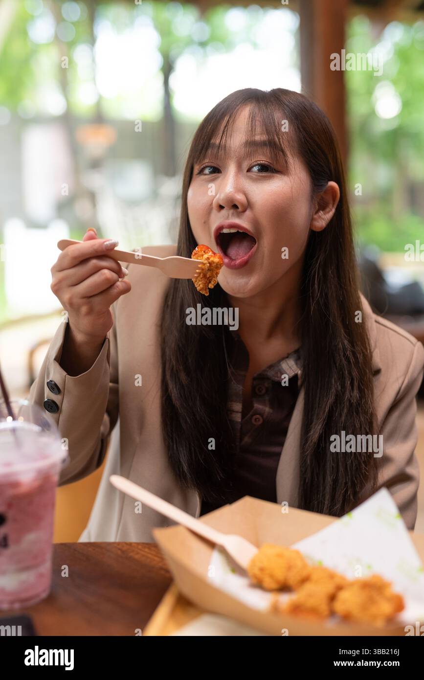 Woman eating fried chicken asian hi-res stock photography and images ...