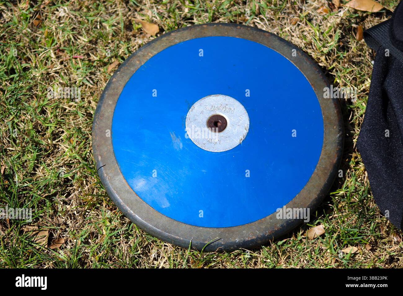 Blue Track and Field Discus on Grass Surface Outdoors Stock Photo - Alamy