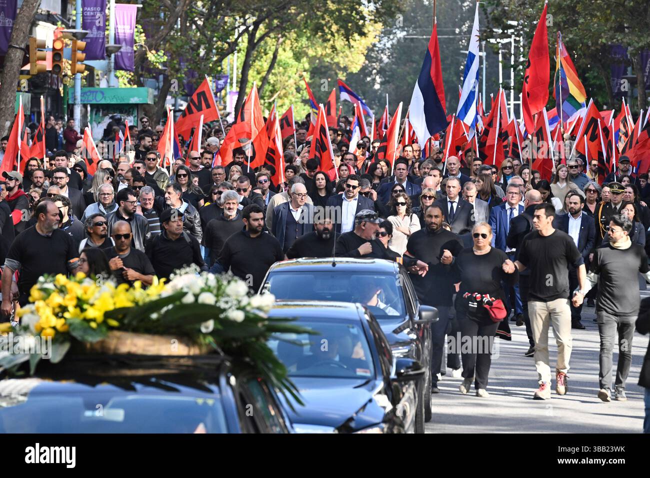Supporters walk alongside the casket of former President Jose Mujica ...