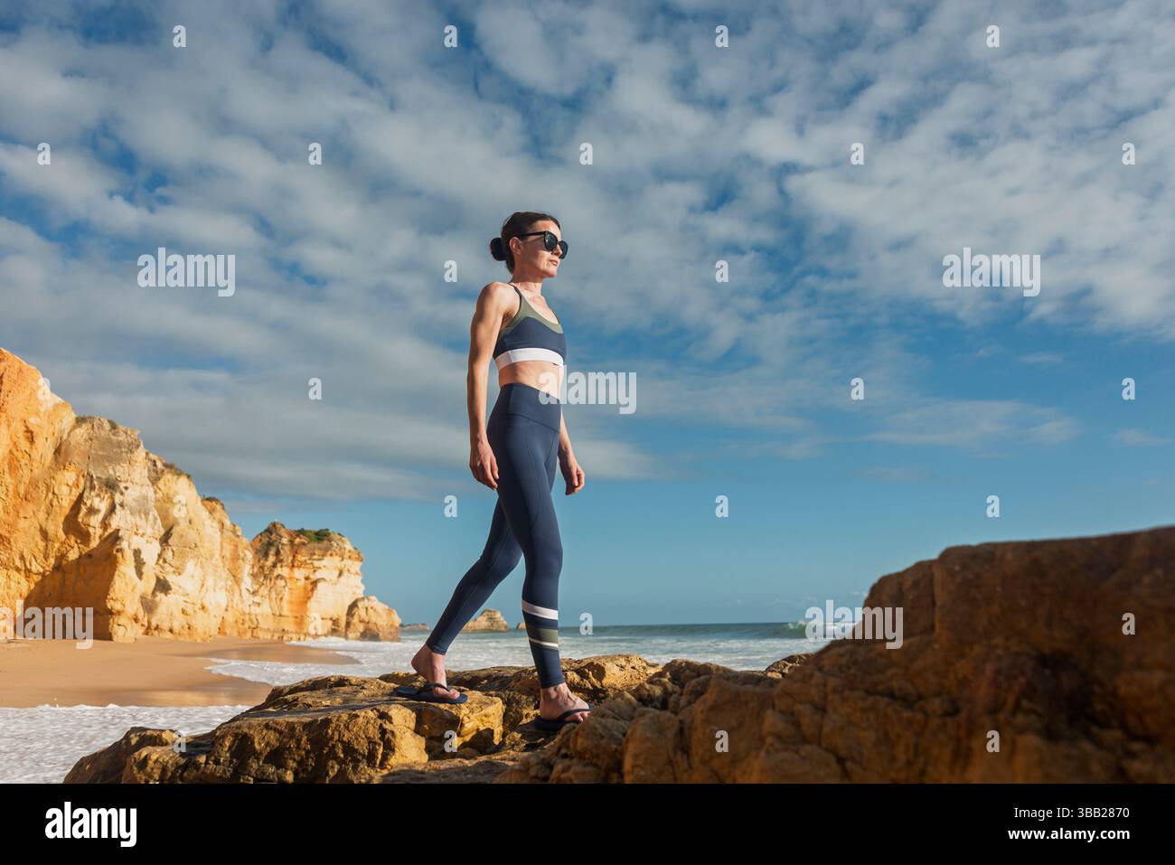 Woman walk across beach hi-res stock photography and images - Alamy
