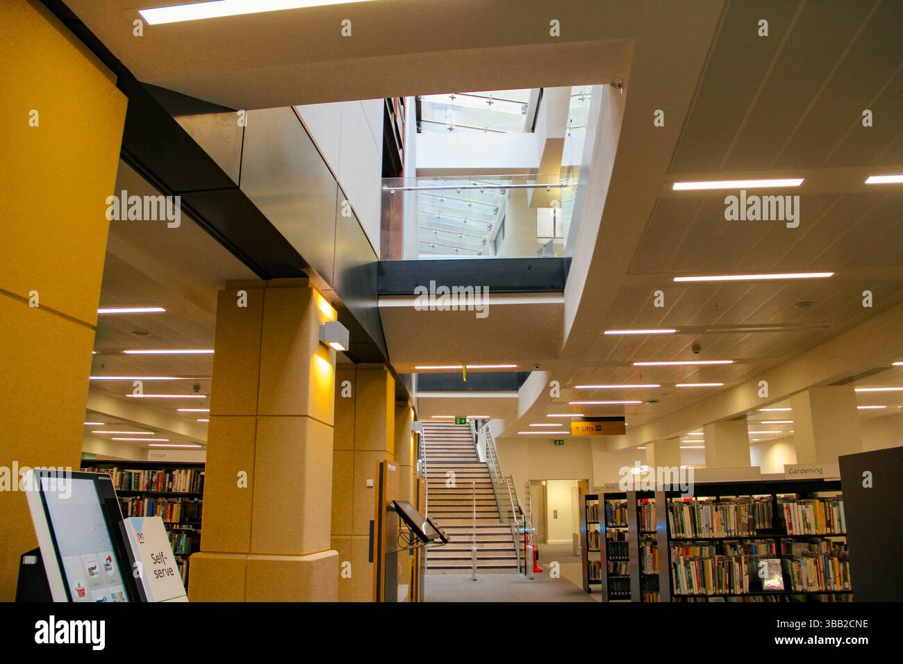 Bright public library interior in Manchester, with rows of books and a ...