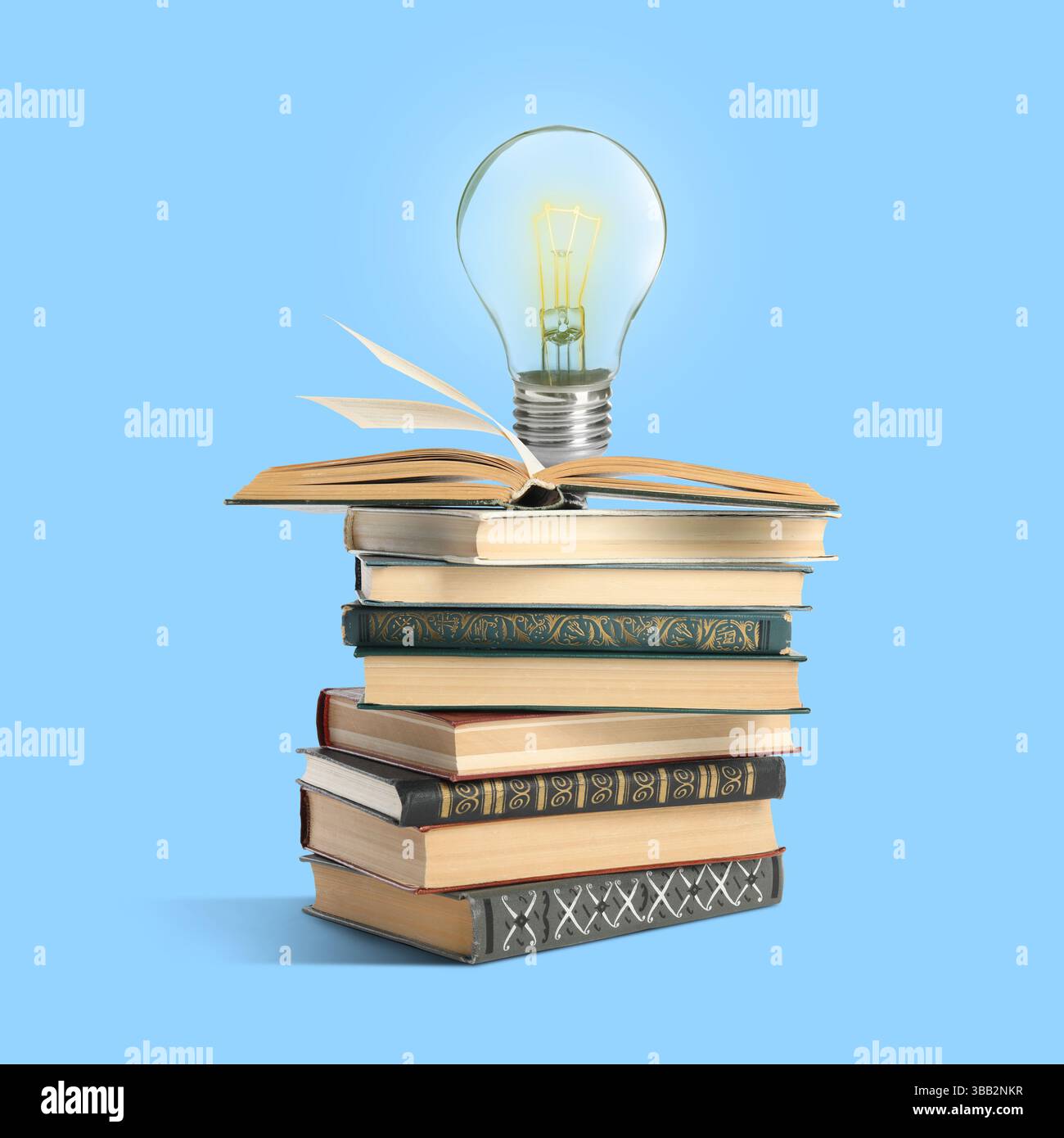 Light bulb on stack of books against light blue background. Idea and ...