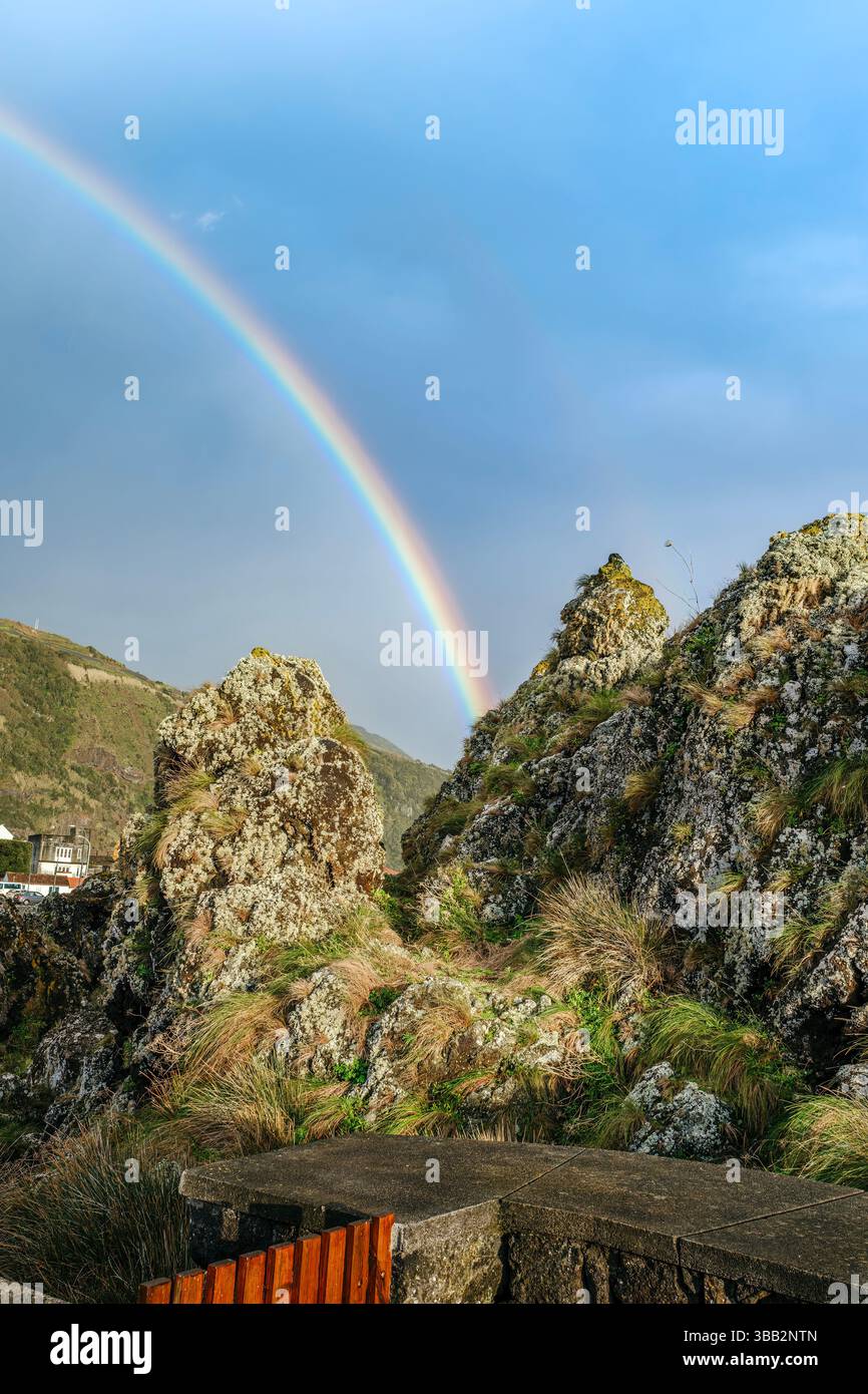 Double Rainbow Arches Over Rocky Landscape. Vibrant primary and ...