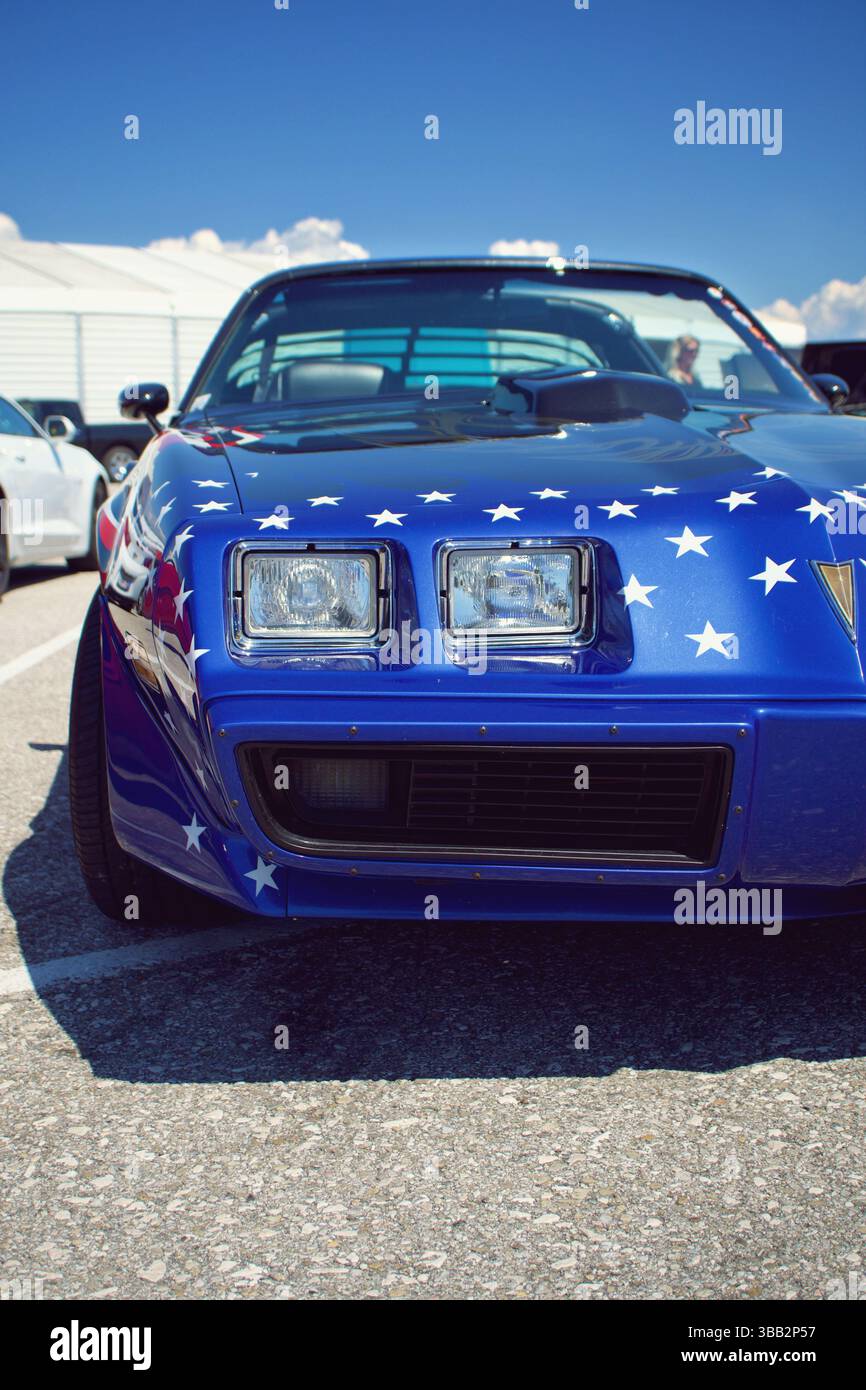 Front view of a blue Pontiac Firebird Trans Am with star-spangled ...