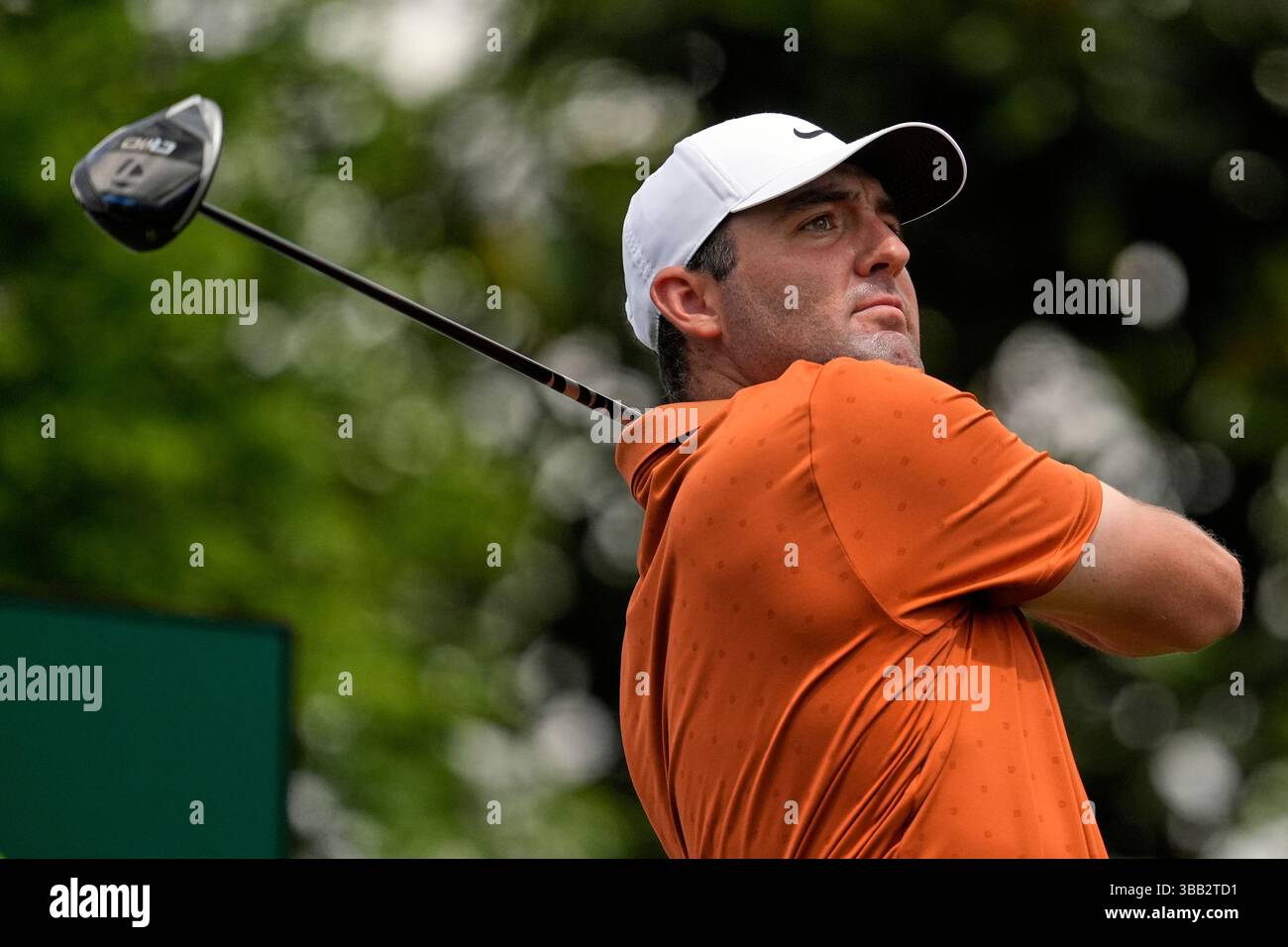 Scottie Scheffler watches his tee shot on the 14th hole during a ...