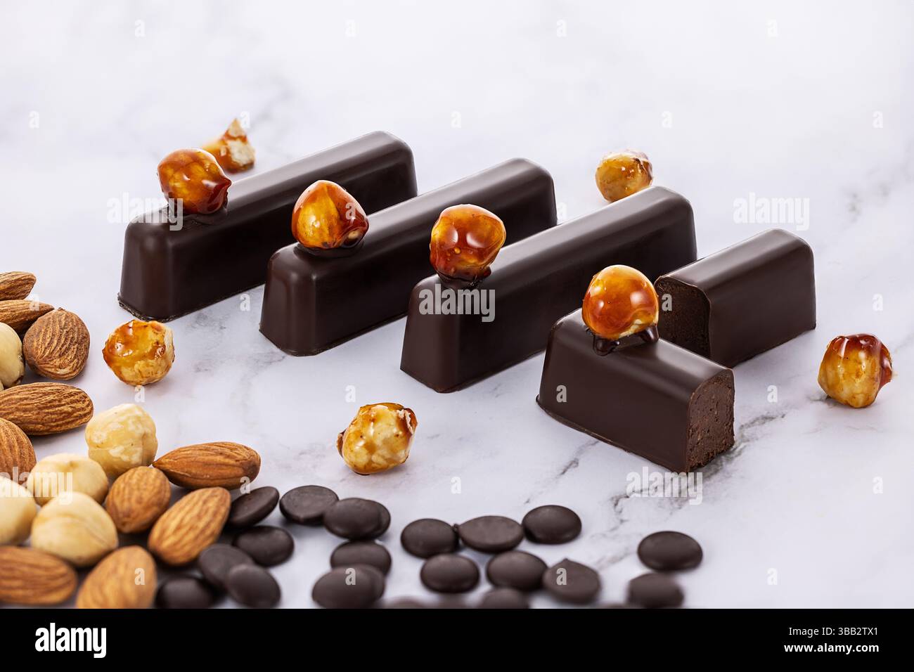 Delicious Chocolate Bars with Hazelnuts on Marble Background Stock ...
