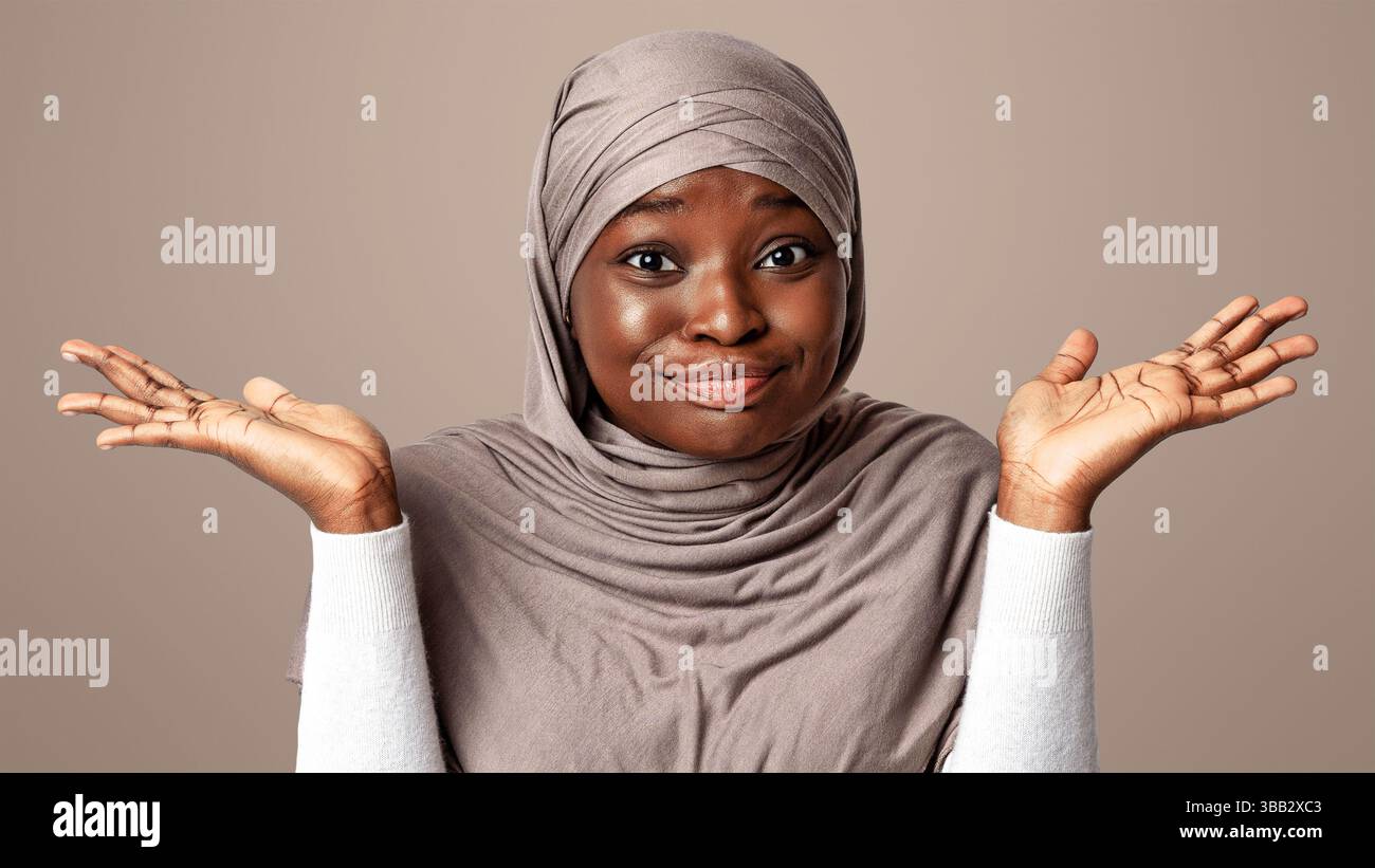 I Don't Know. Doubtful Black Muslim Lady Shrugging Shoulders And ...